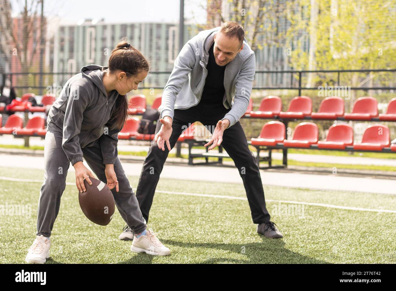 Family Playing American Football Together In Park Stock Photo - Alamy
