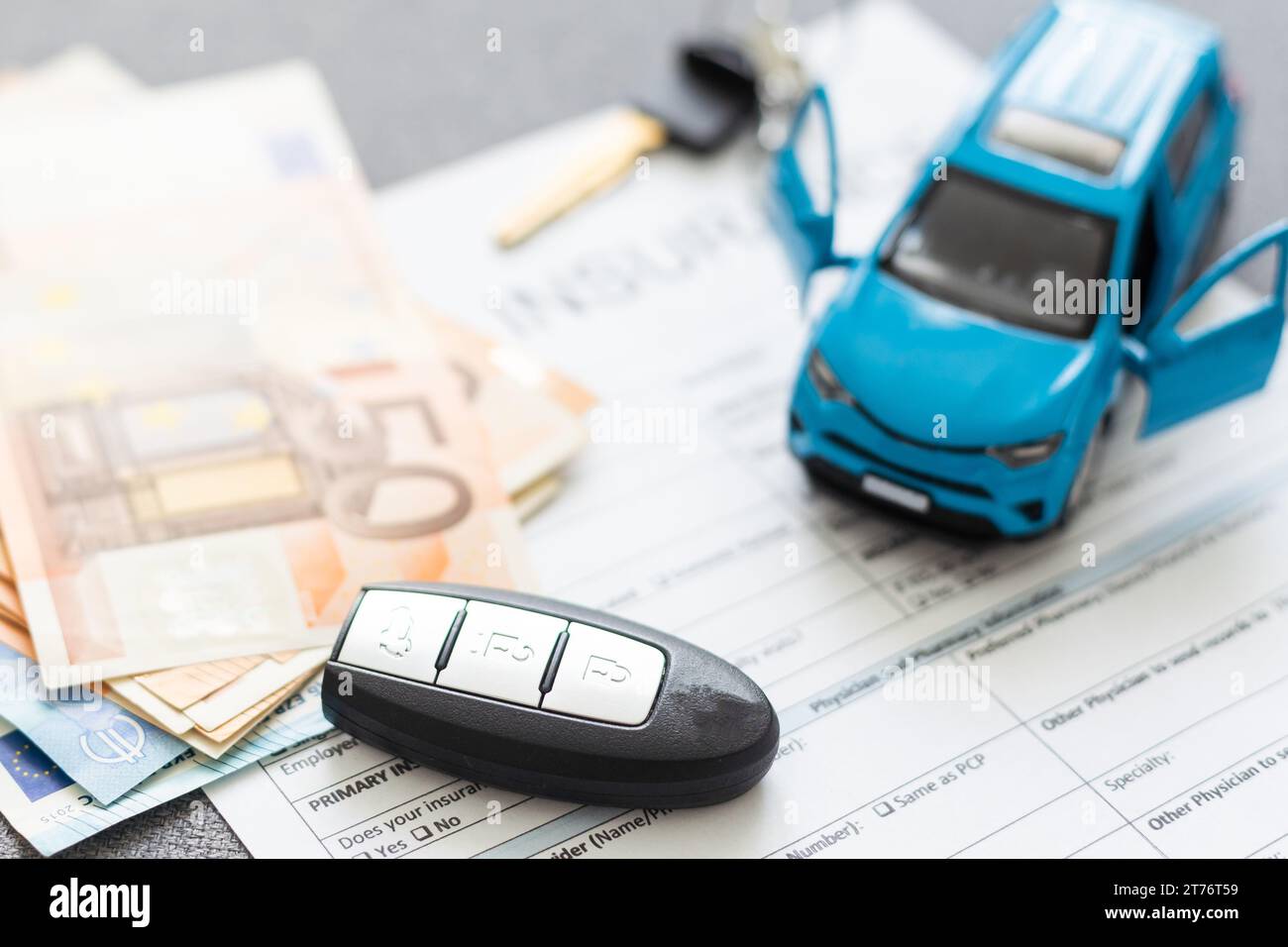 Car insurance form with car key and toy car Stock Photo - Alamy
