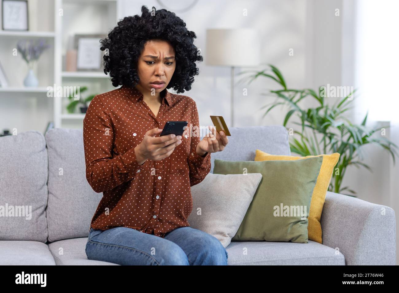 Upset unhappy and cheated woman sitting at home on sofa in living room ...