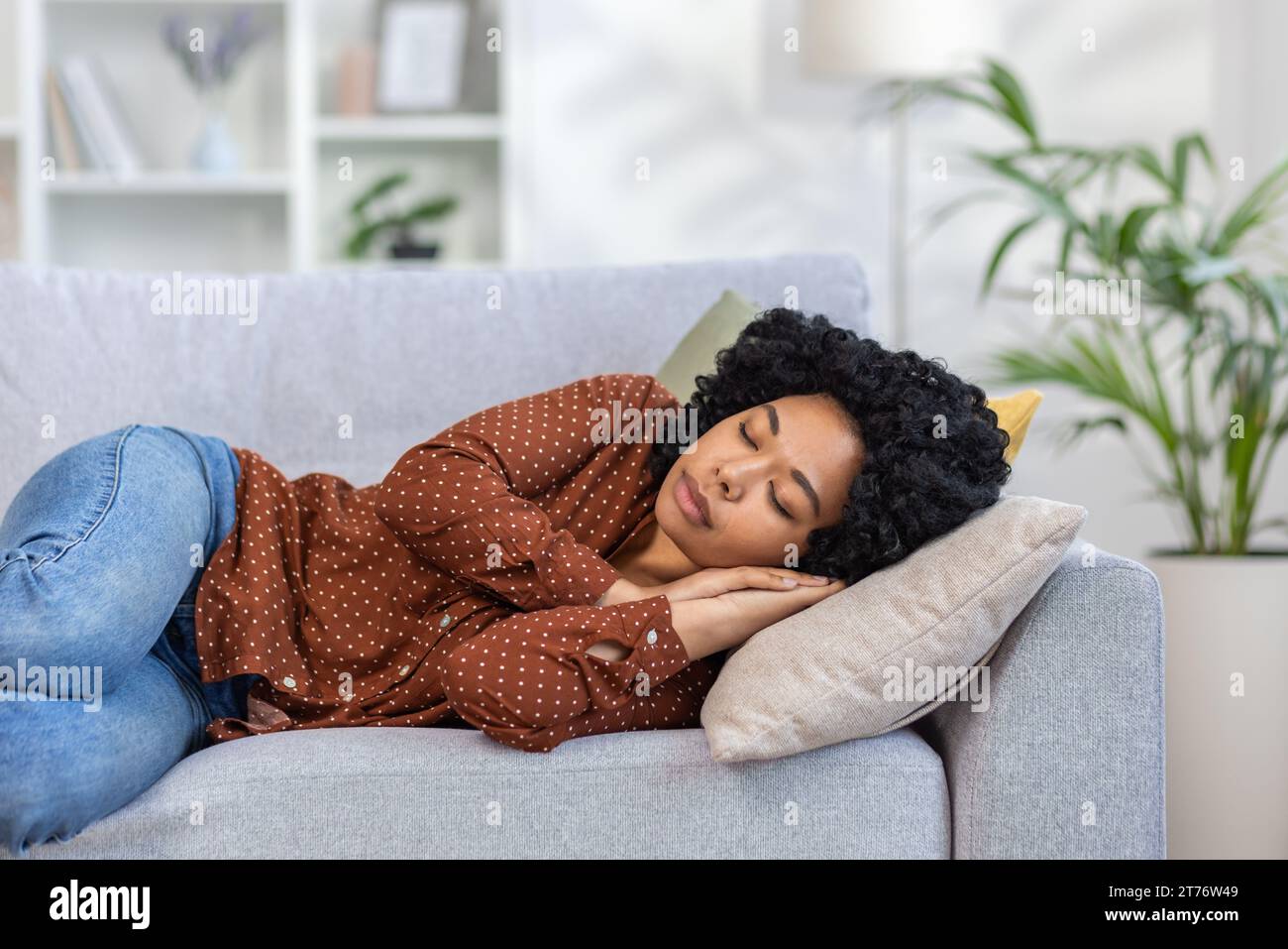 Young beautiful woman resting at home after work, African American ...
