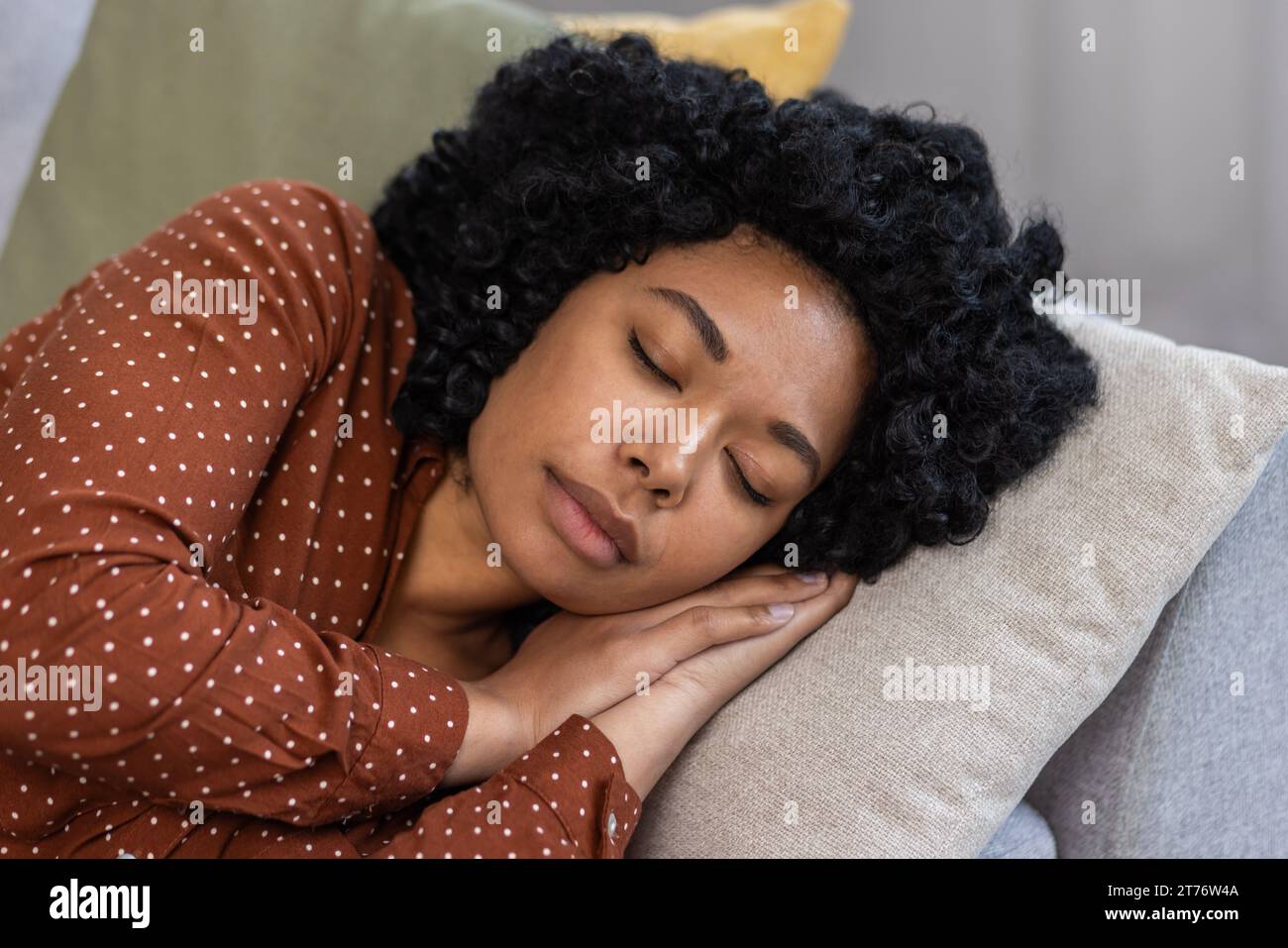 Young beautiful woman resting at home after work, African American ...