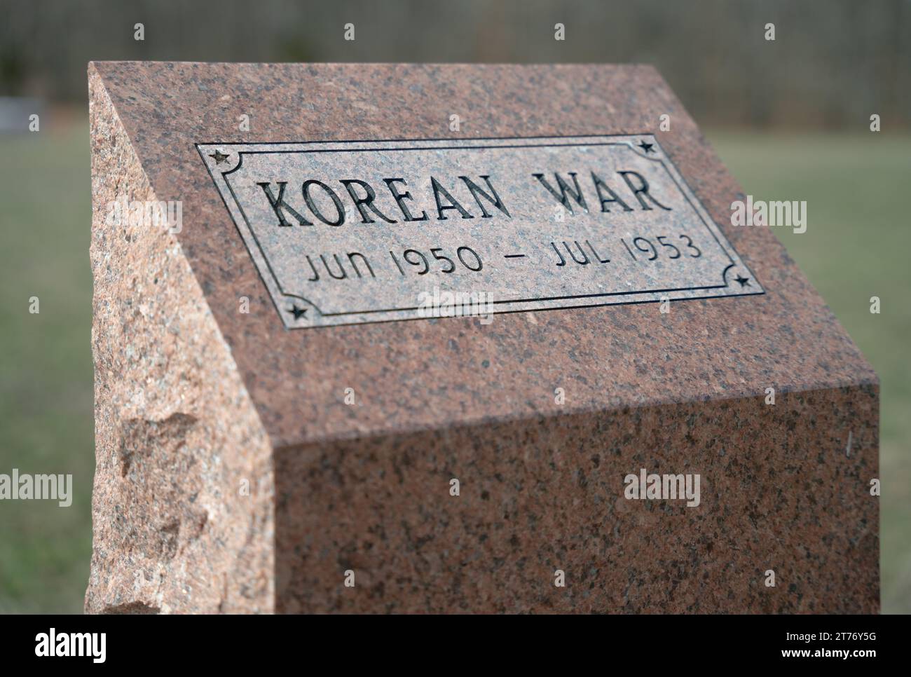 A granite memorial stone with a Korean War engraving at its base Stock ...