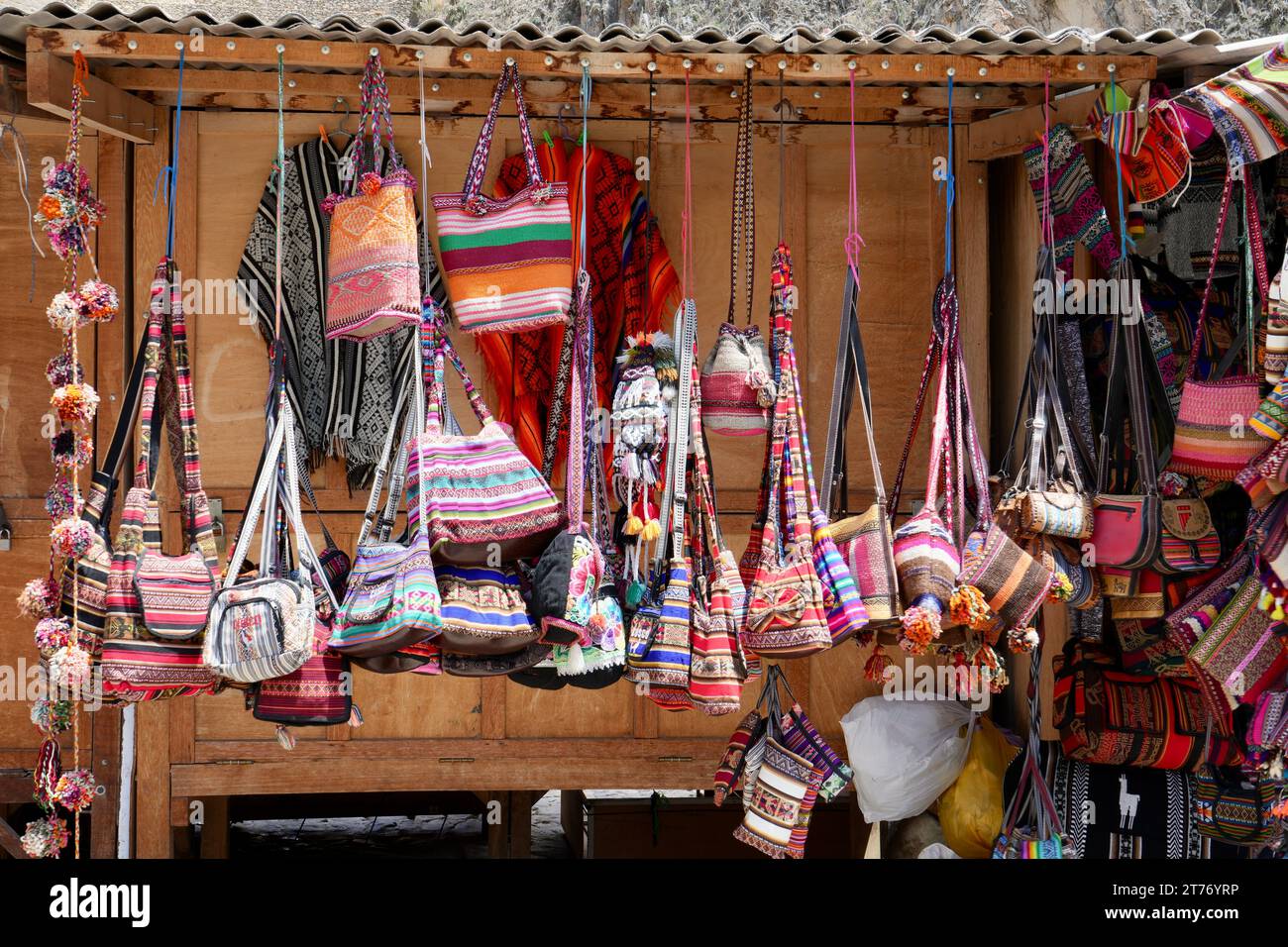Traditional Peruvian Bags and Textiles in a market stall. Ollantaytambo ...
