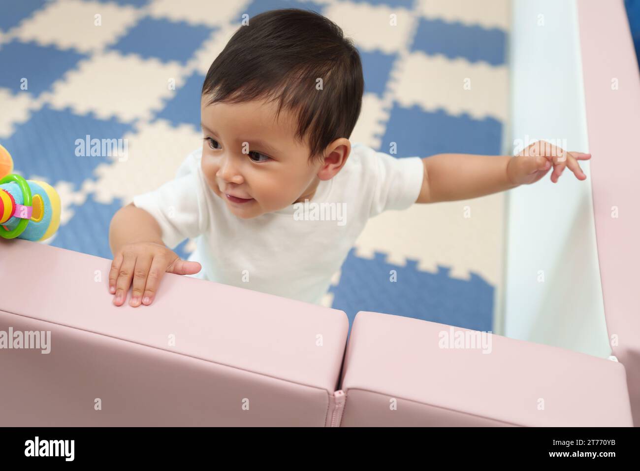 happy infant baby standing in a fence of playpen Stock Photo - Alamy