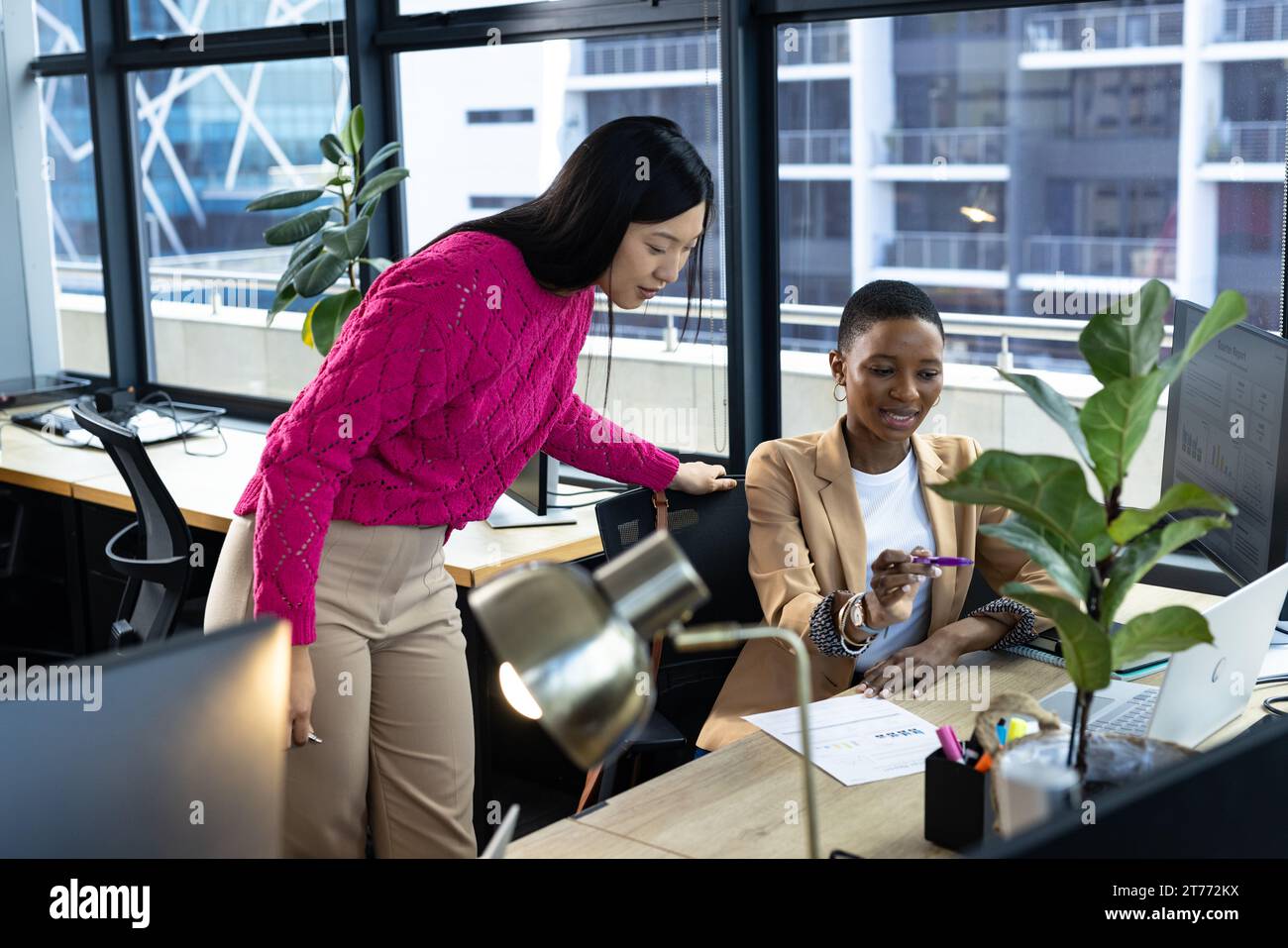 Happy diverse female colleagues using hi-res stock photography and ...