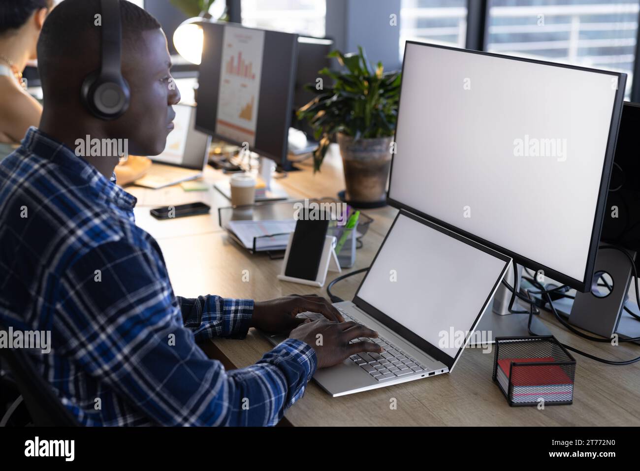 African american casual businessman in office using laptop and computer ...