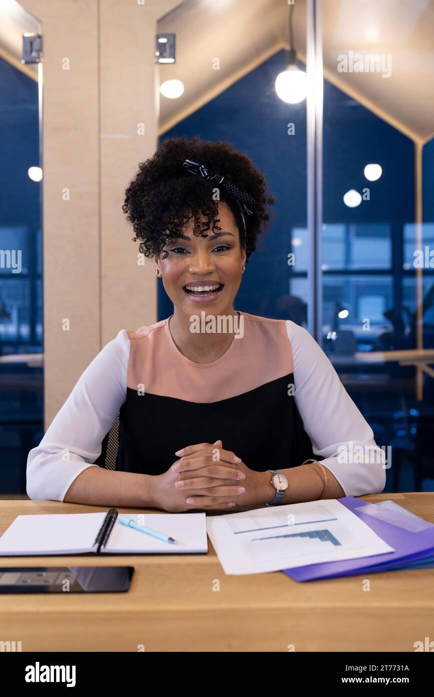 Happy biracial casual businesswoman smiling during video call at office ...