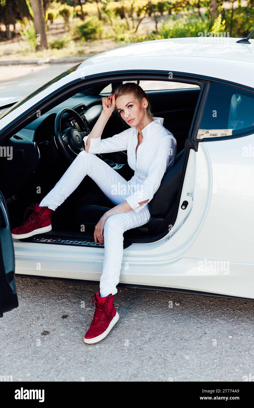 tired girl taxi driver driving a car on the road in traffic jam Stock ...