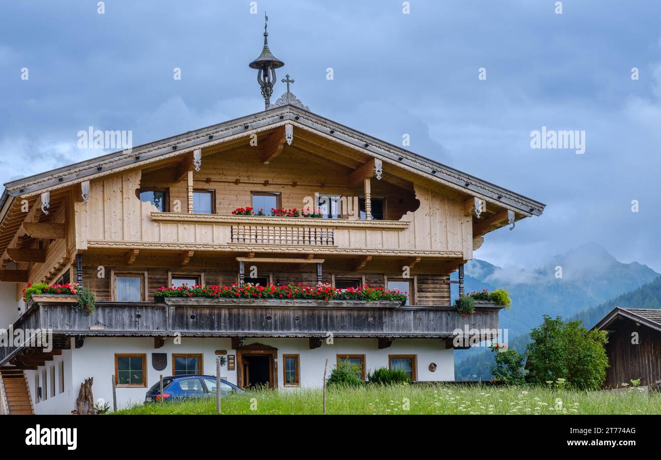 Traditional Austrian wooden house with balconies with flower boxes ...