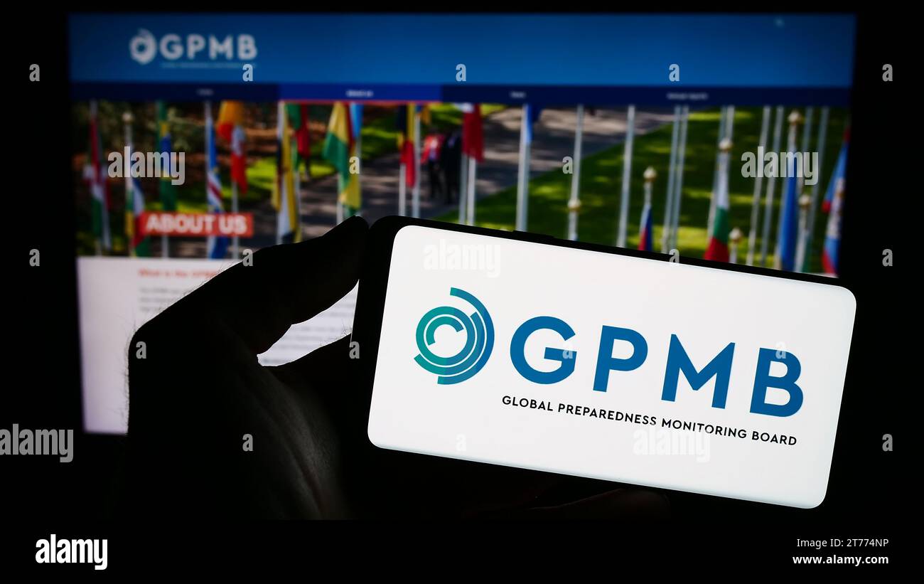 Person holding smartphone with logo of Global Preparedness Monitoring ...