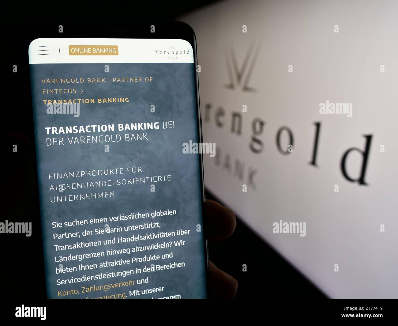 Person holding mobile phone with web page of German financial services ...