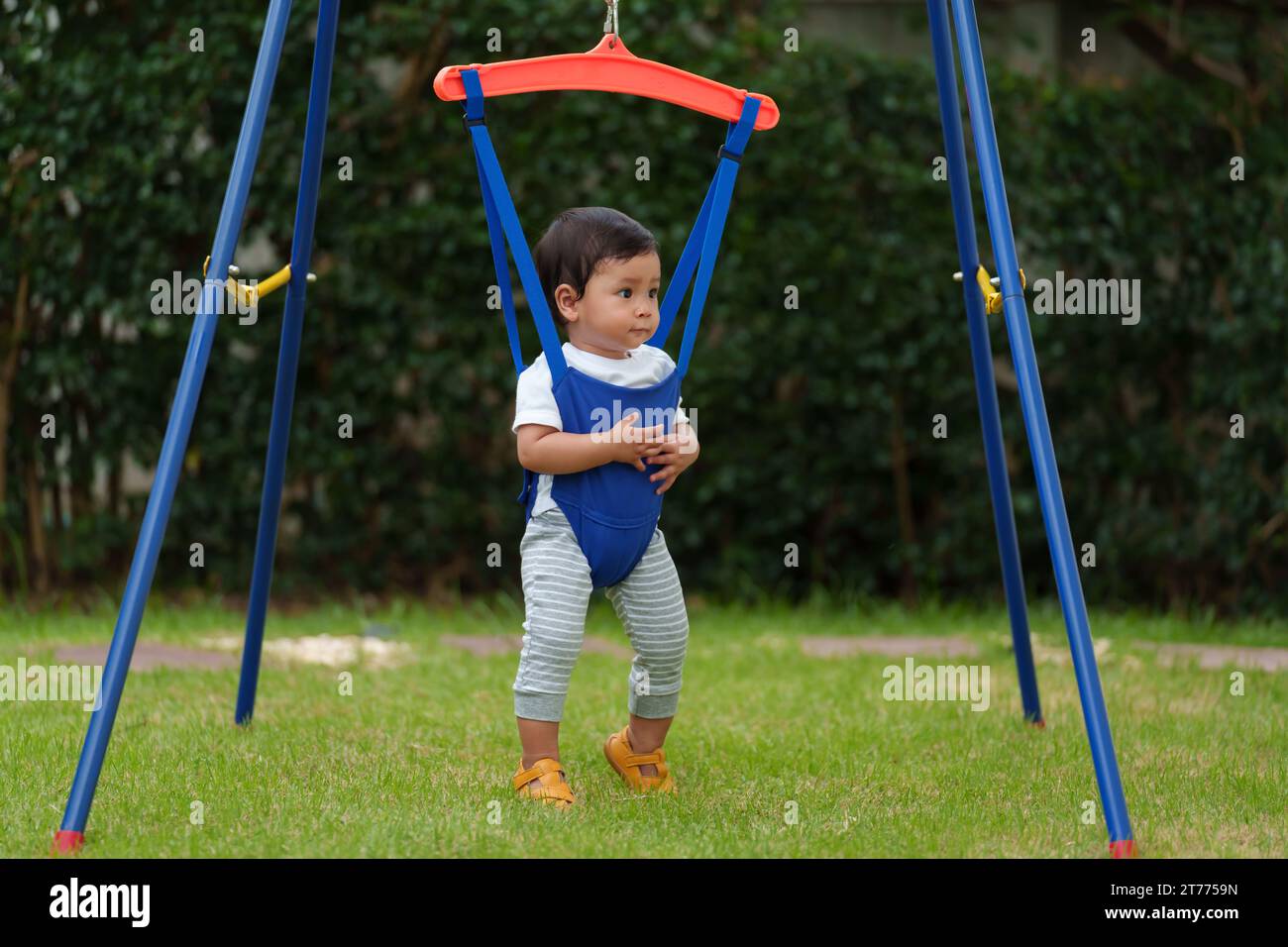 Baby boy in baby swing hi-res stock photography and images - Alamy