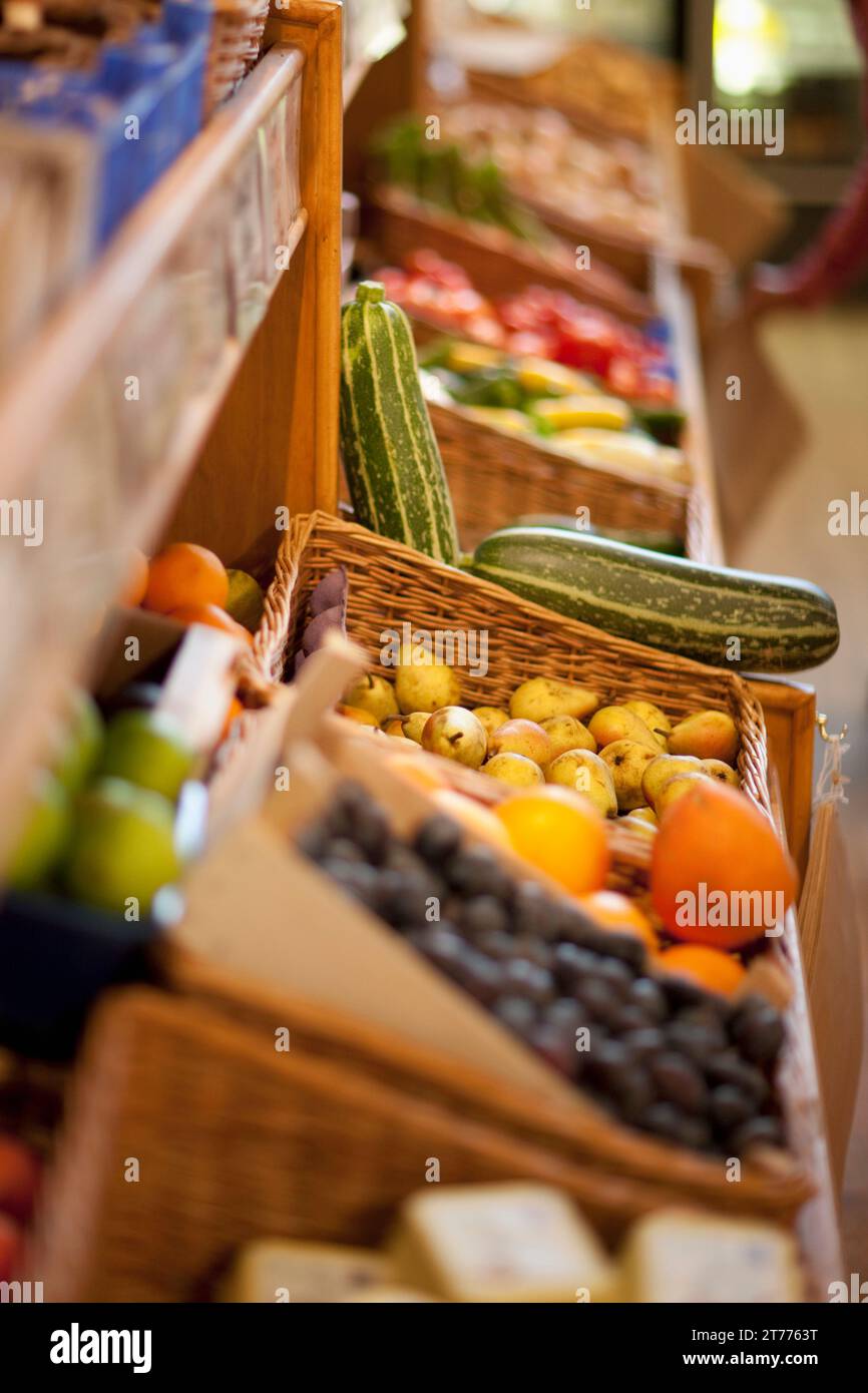 Baskets filled with fresh fruit and vegetables in a grocery shop Stock ...