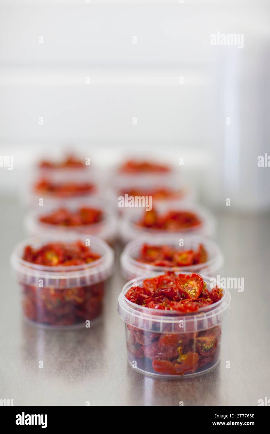 Plastic containers filled with sun dried tomatoes Stock Photo - Alamy