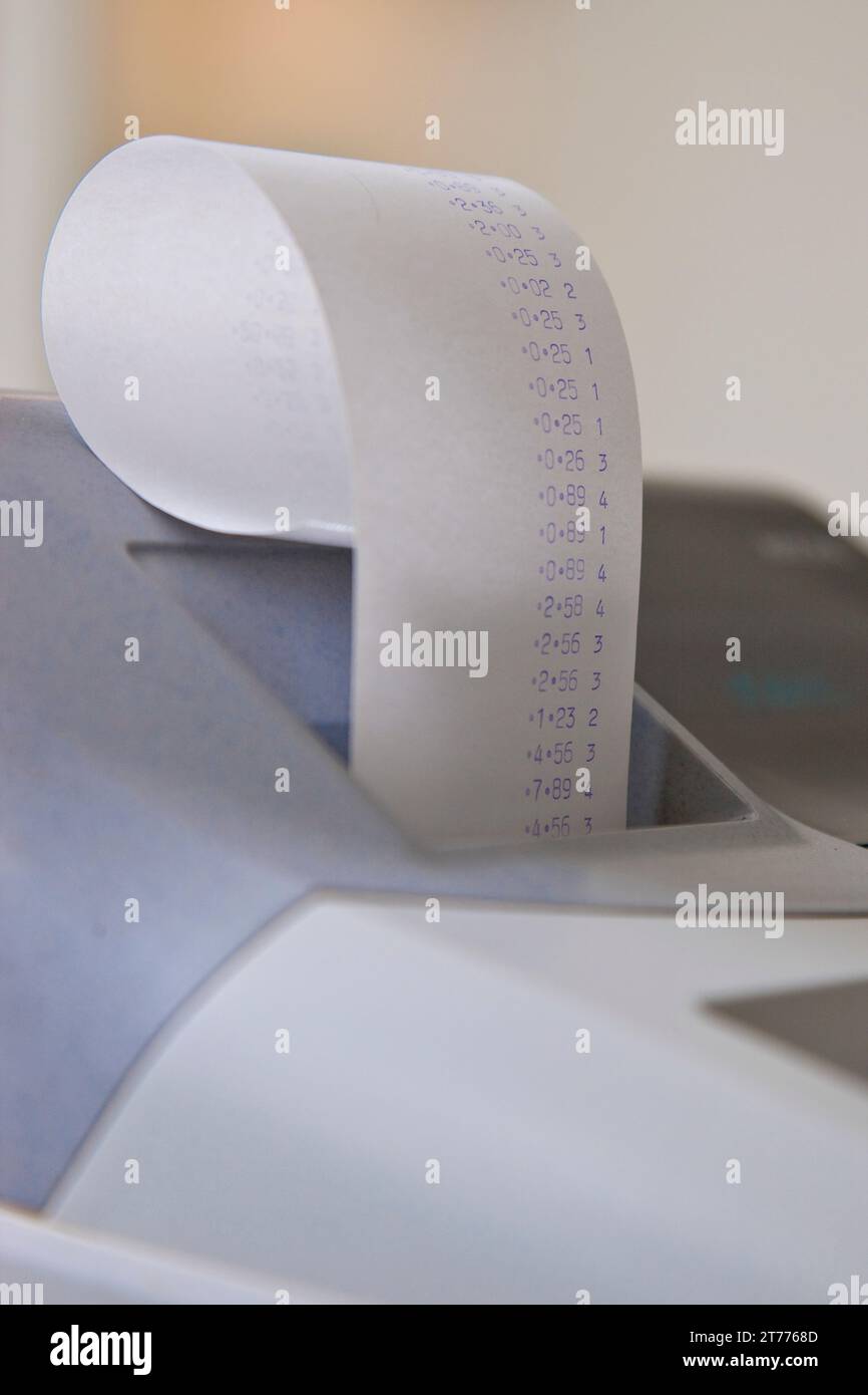 Close up of a cash register with receipt coming out of it Stock Photo ...
