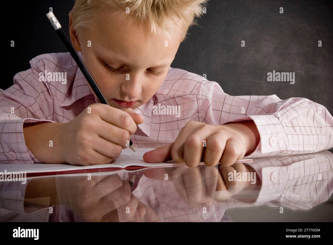 Boy sitting at desk hi-res stock photography and images - Alamy