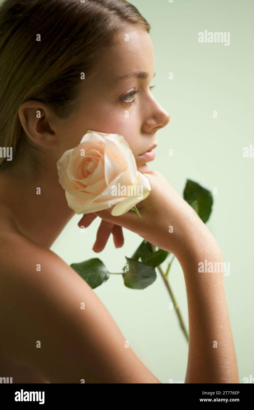 Female holding rose head in hi-res stock photography and images - Alamy