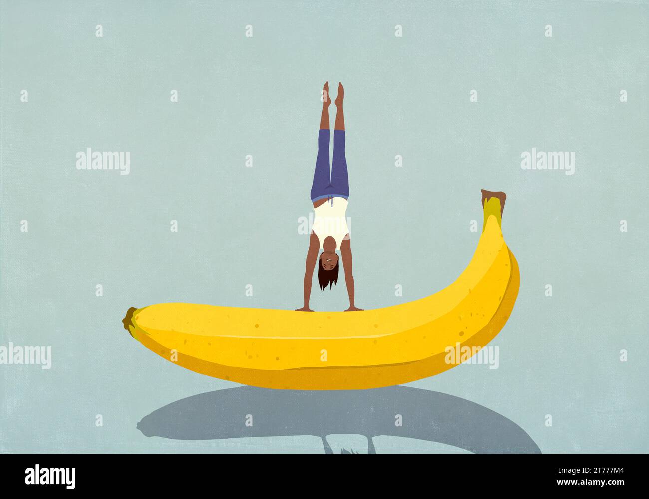 Healthy woman balancing upside-down on banana Stock Photo - Alamy