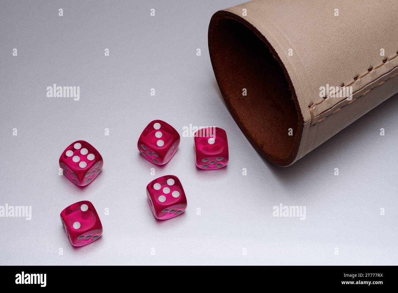 Still life red dice and leather cup on white background Stock Photo - Alamy