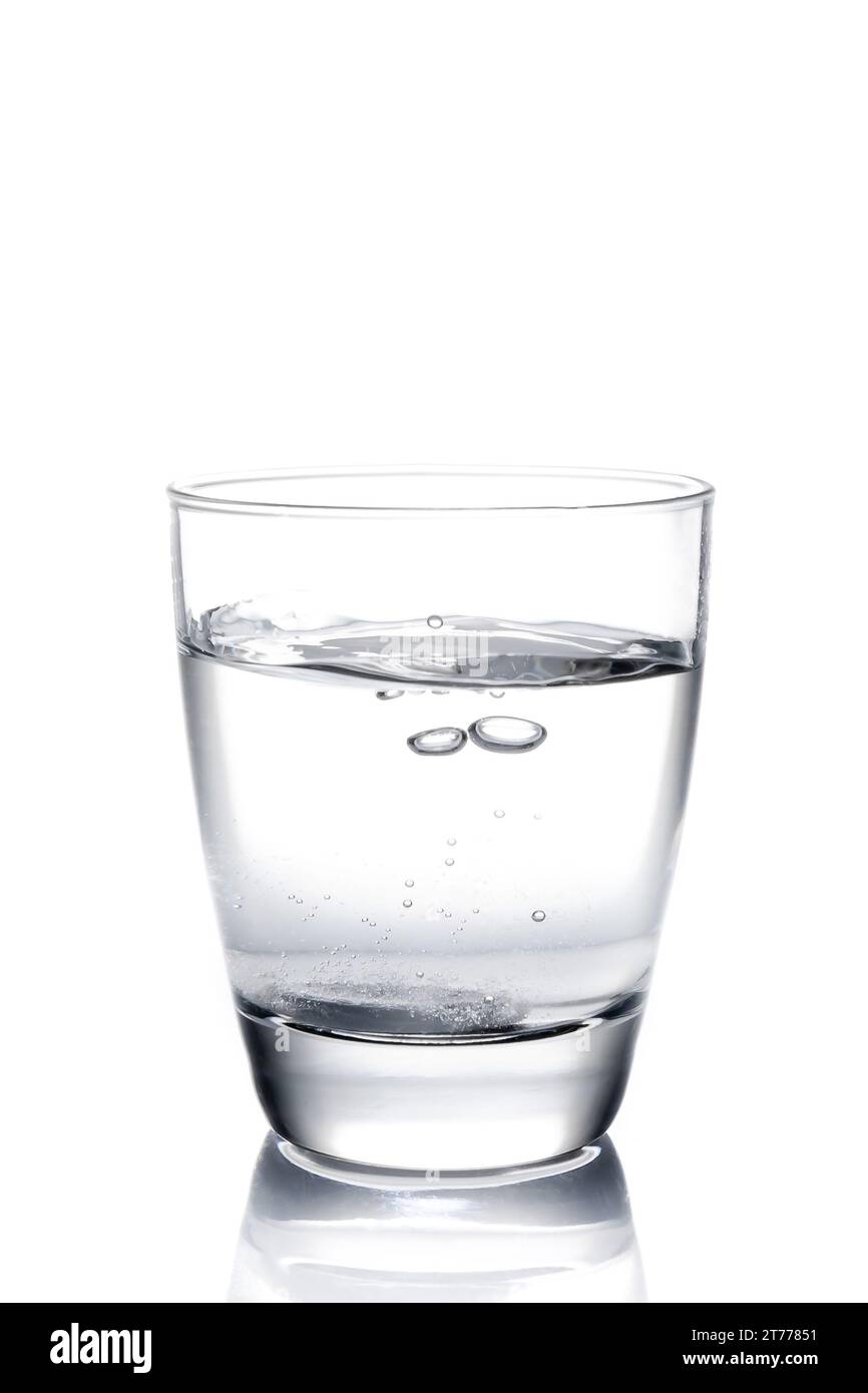tablet dropped into the water on white background Stock Photo - Alamy