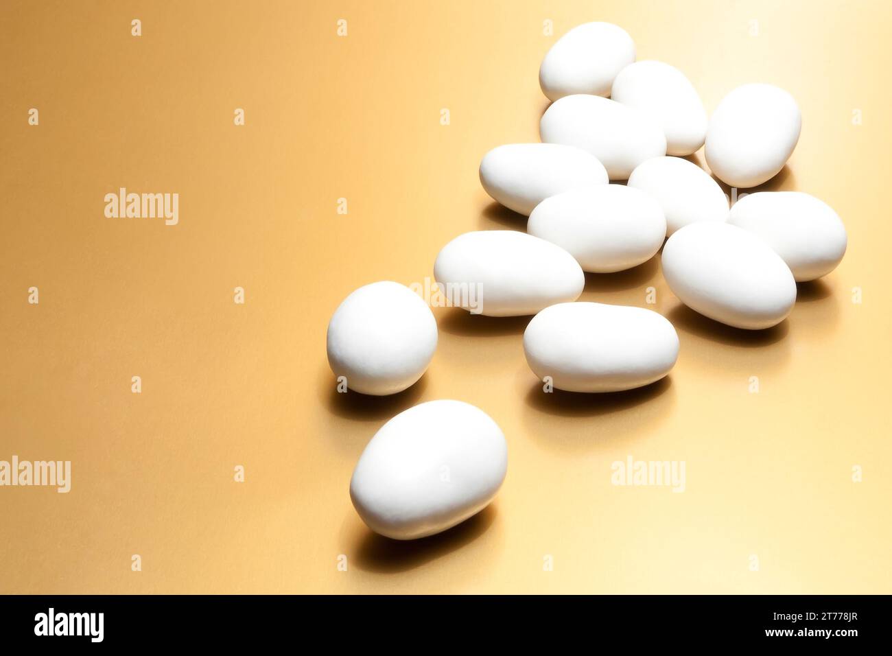 white jordan almonds on golden background with space for text Stock ...