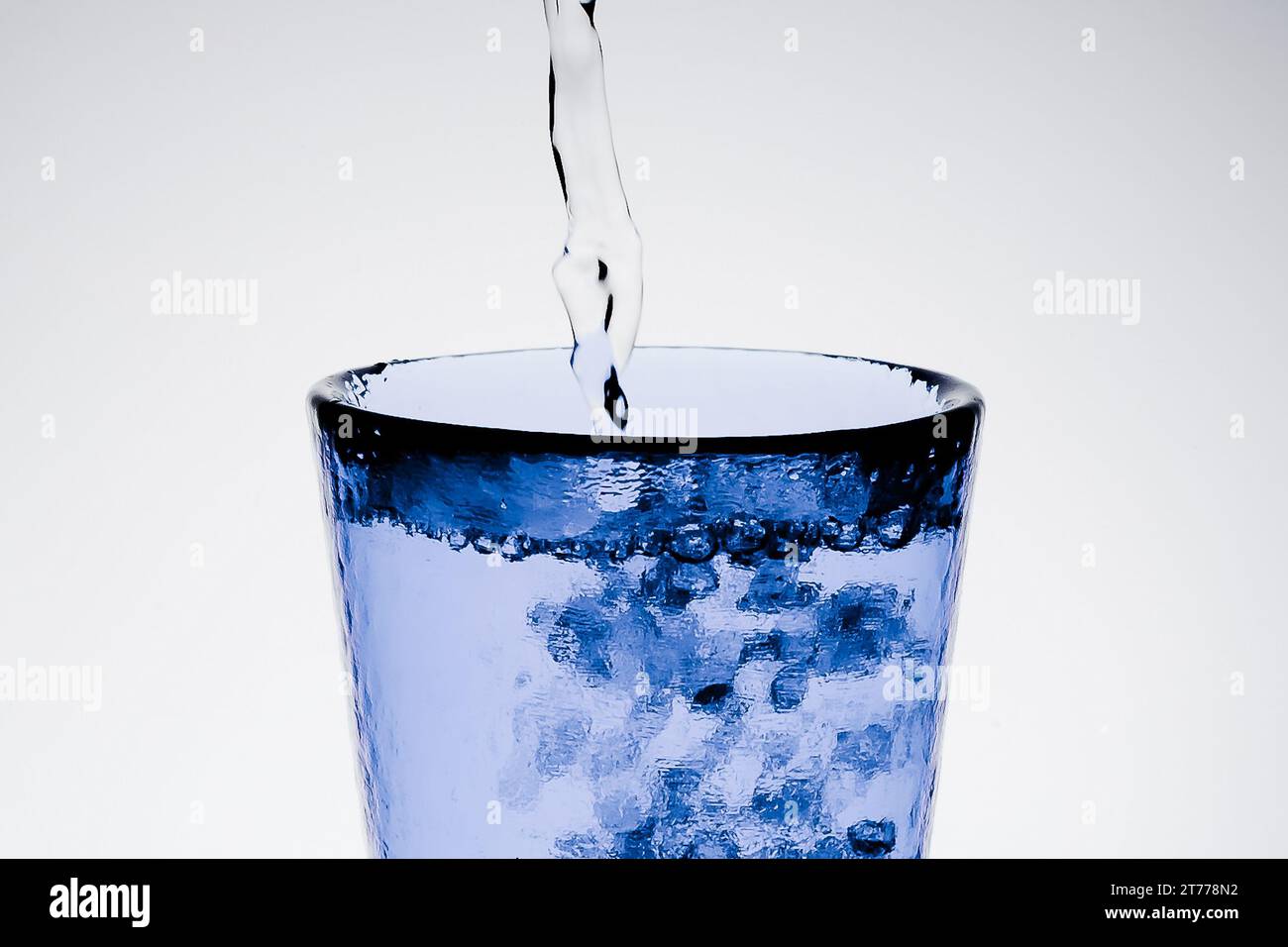 detail of filling a blue glass with pure water and bubbles Stock Photo ...