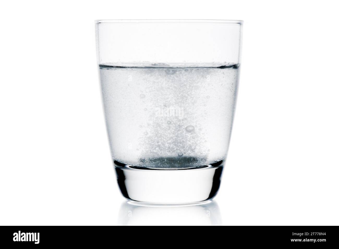 medical tablet dropped into the water with bubbles on white background ...