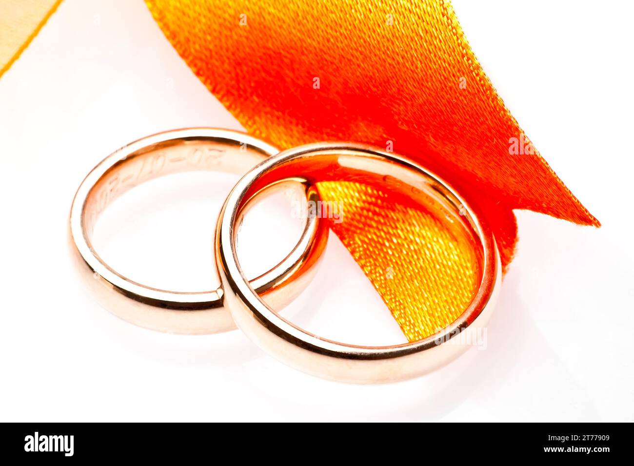 gold wedding rings near ribbon on white background Stock Photo - Alamy
