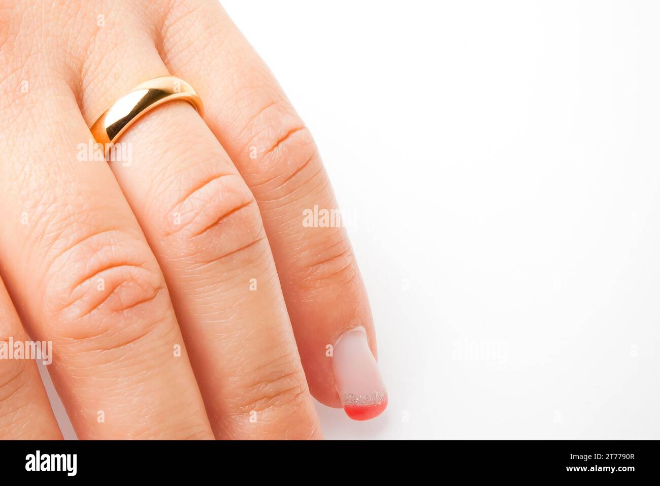 detail of one hand with gold ring with space for text on white ...