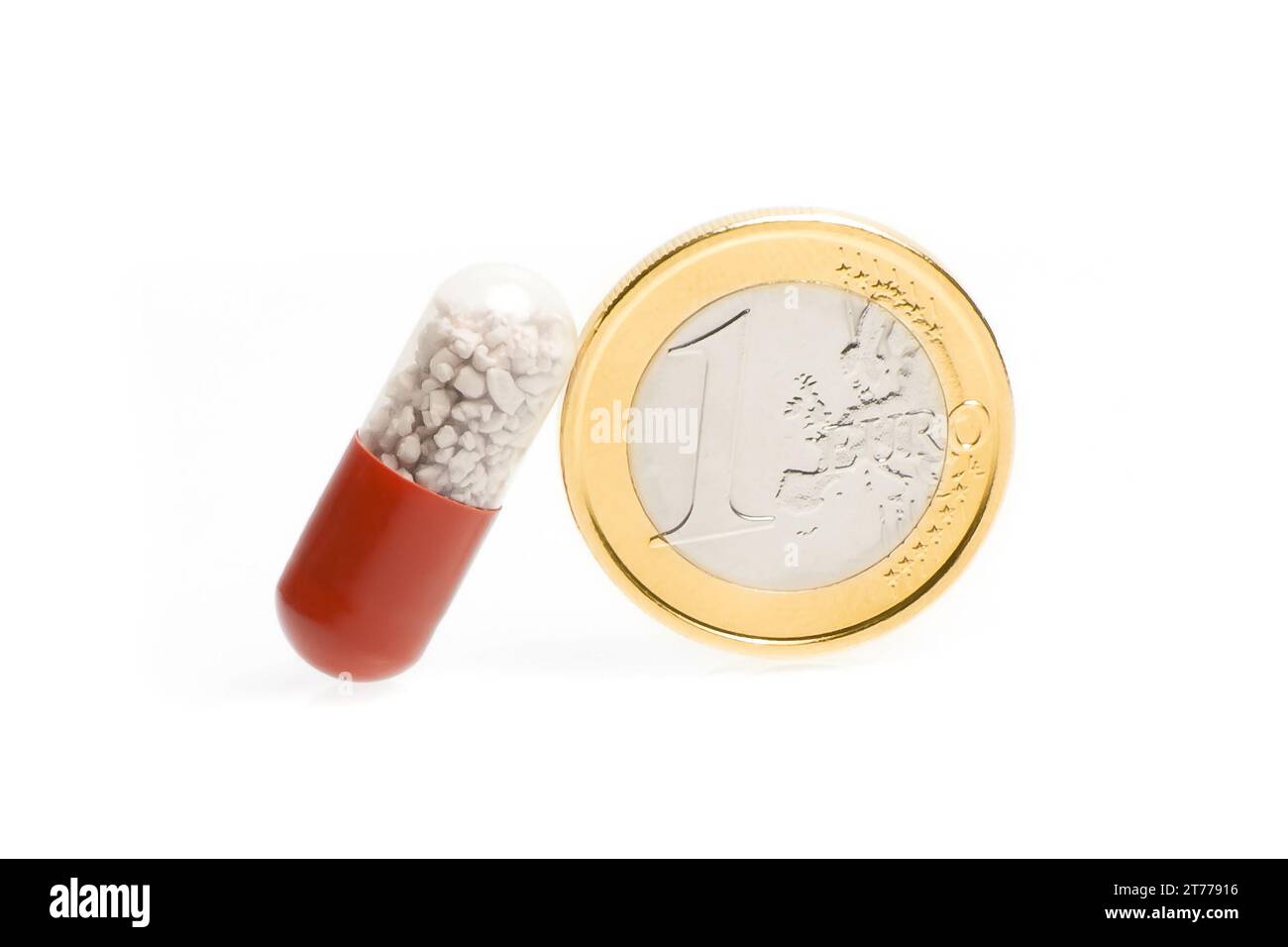 one euro coin and one medical pill on white background Stock Photo - Alamy