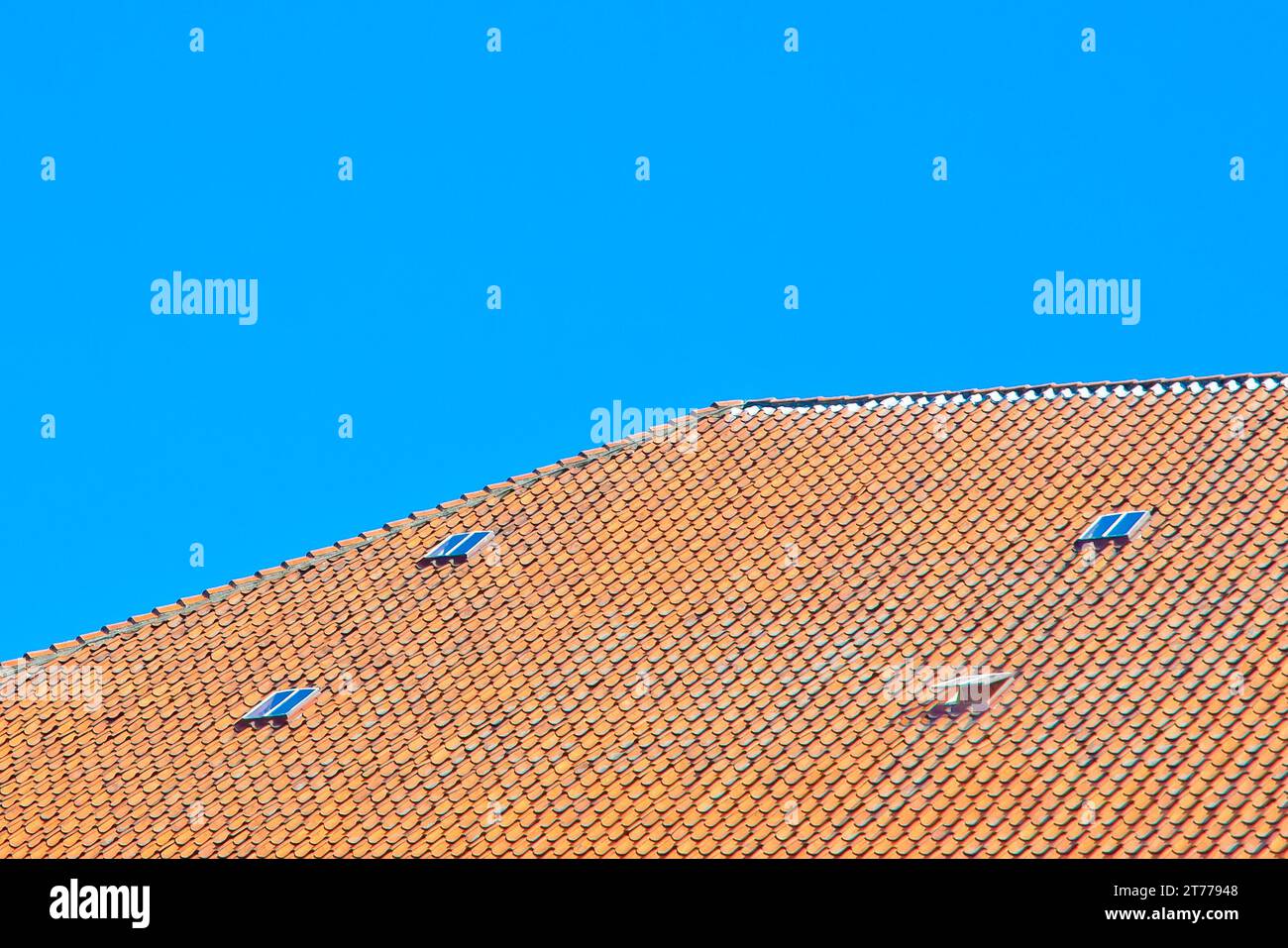 old red rooftop under blue sky Stock Photo - Alamy