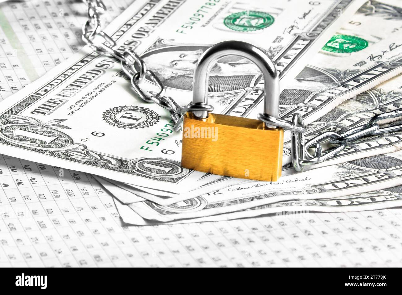 lock security and chain on dollars banknotes on financial newspaper ...
