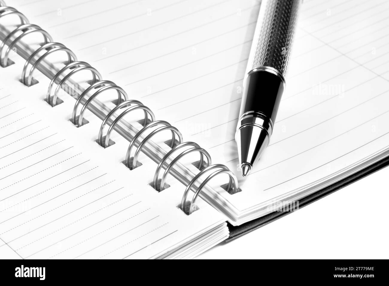 detail of a notebook and business pen in composition on white ...