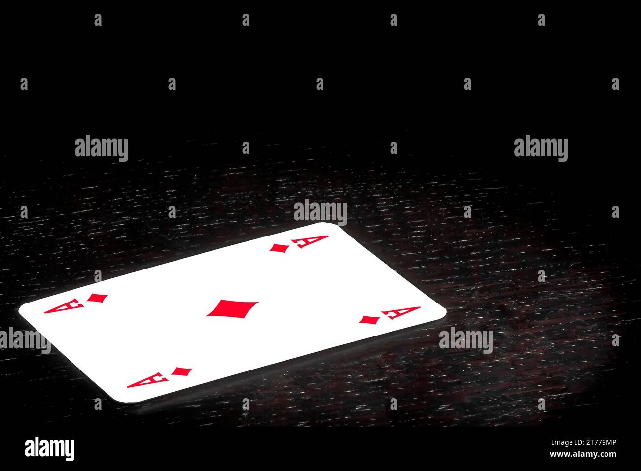 a winning ace on old wood table Stock Photo - Alamy