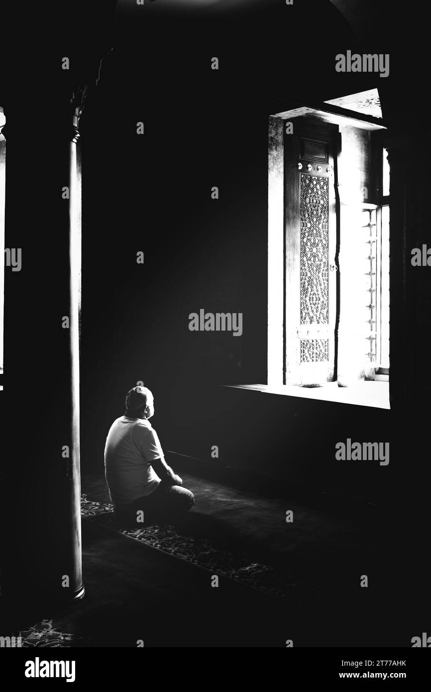 Islamic background vertical photo. Muslim man praying in the mosque ...
