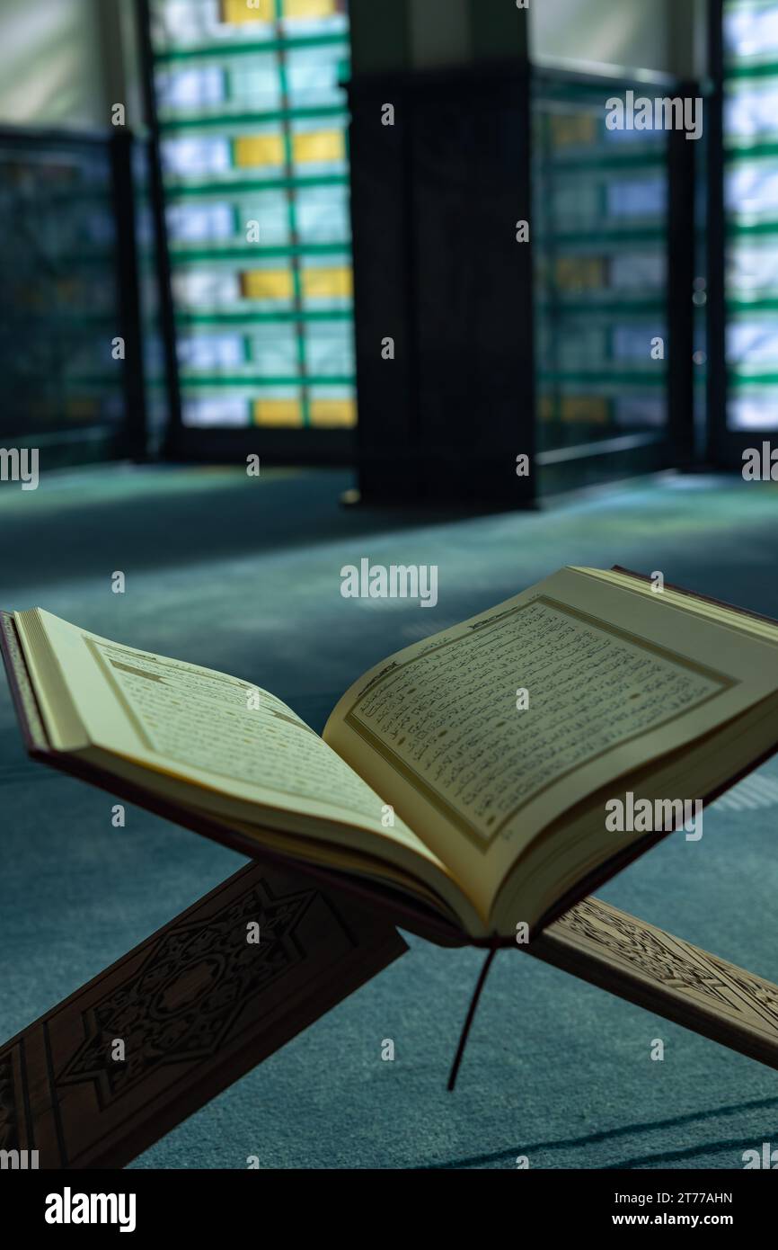 Islamic background vertical photo. The holy Quran on the lectern in a ...