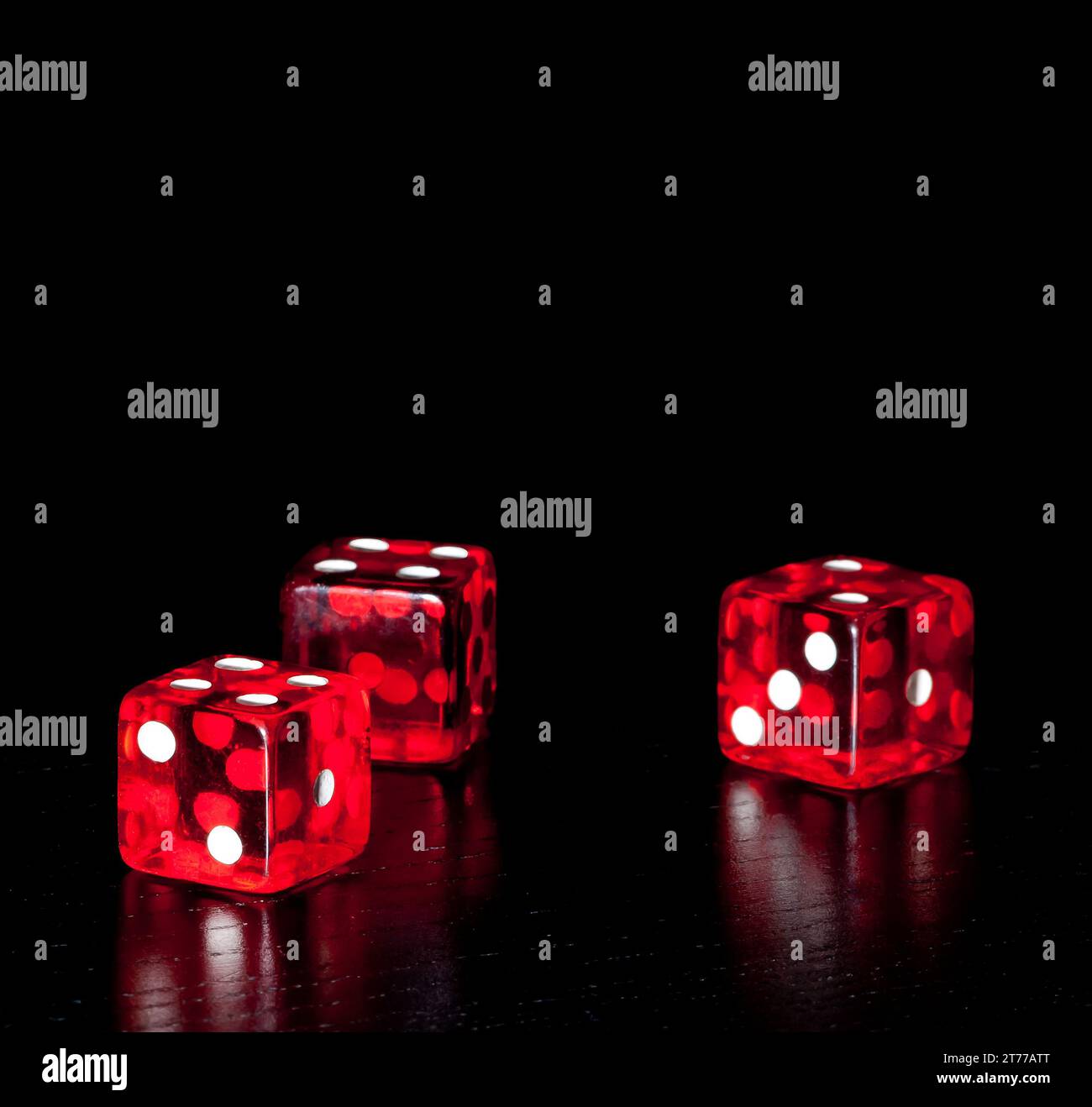 three red dice on old wood black table on black background with space ...