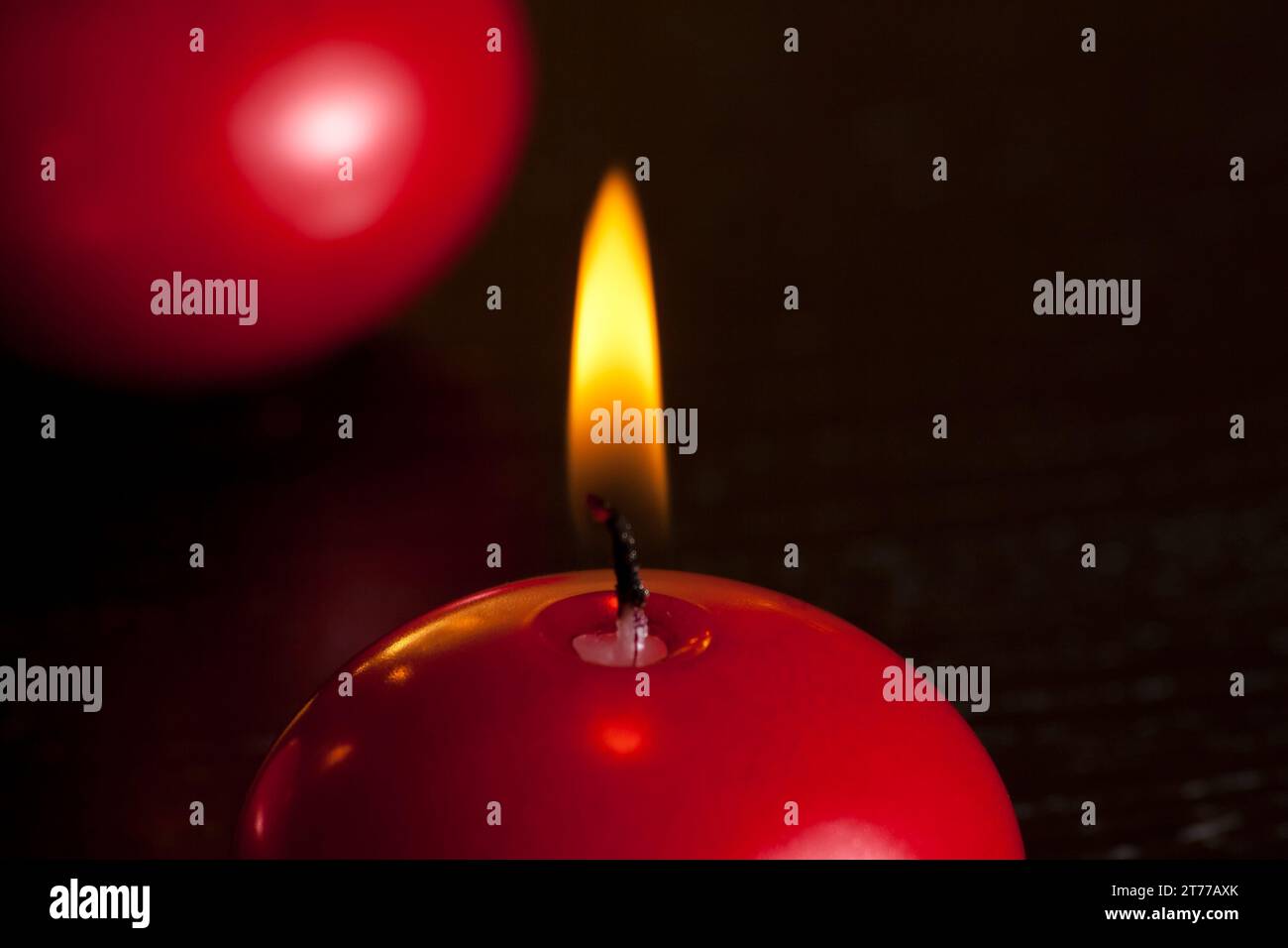 detail of a red christmas candle on wood table background with space ...