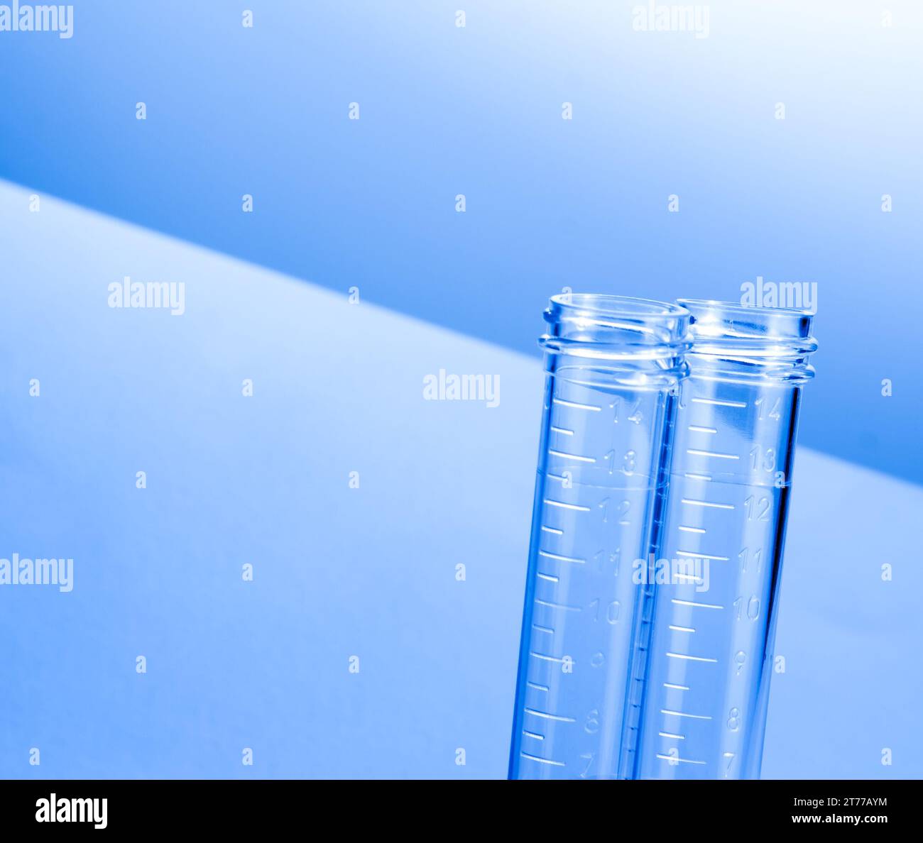 empty test tubes in laboratory on table and blue light tint background ...