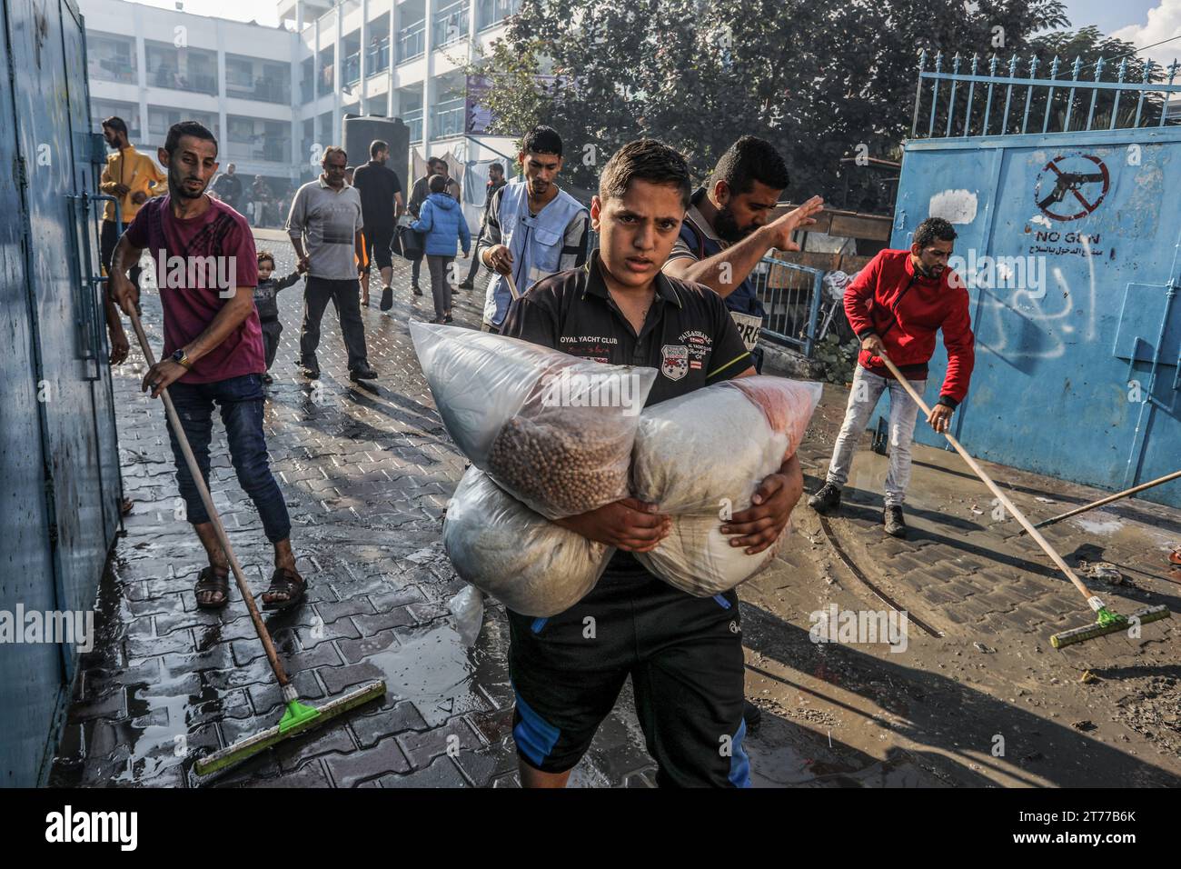Rafah, Palestinian Territories. 14th Nov, 2023. A boy walks with sacks ...