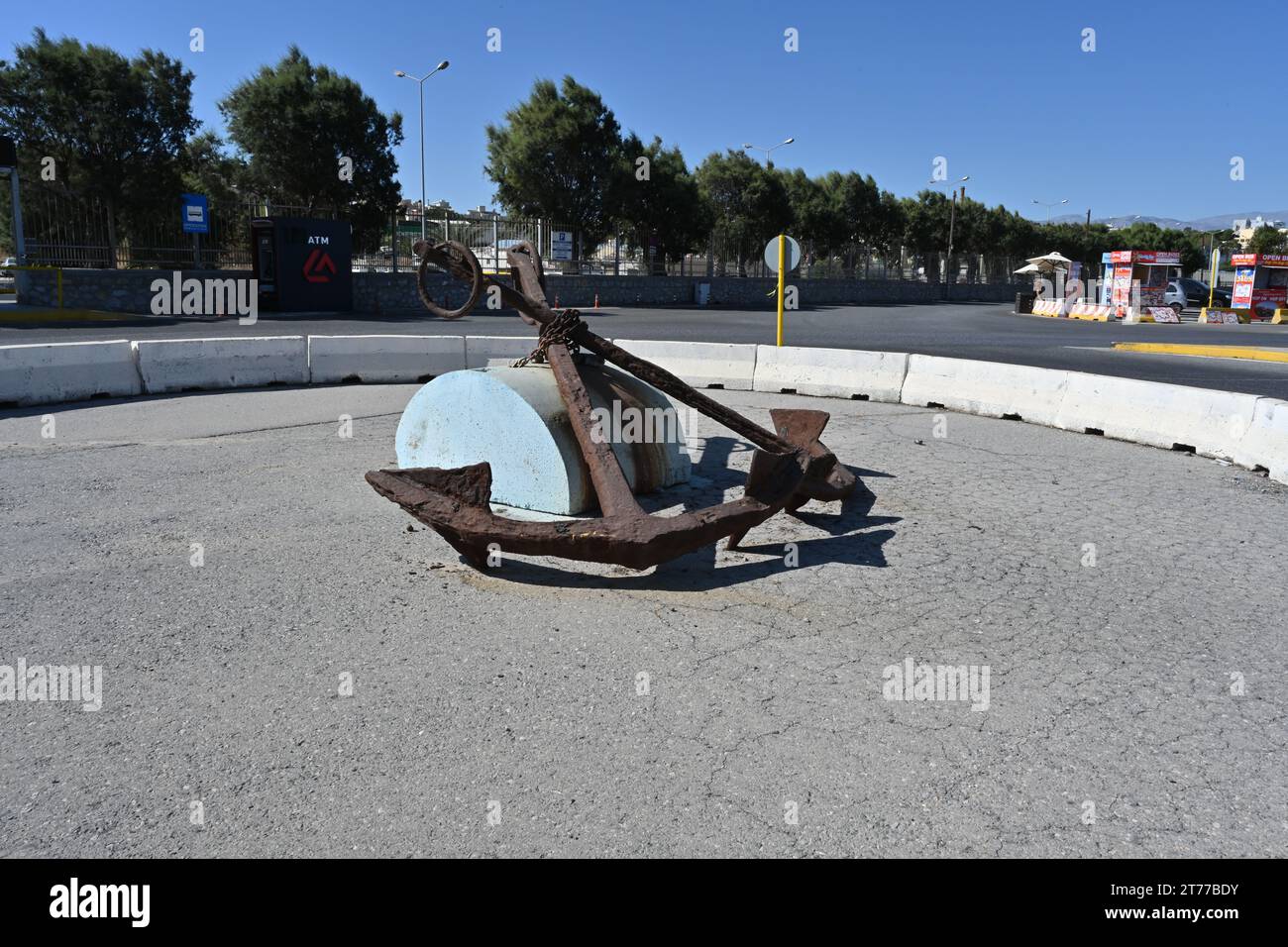 Old rusty anchor with chain placed in the middle of roundabout with ...
