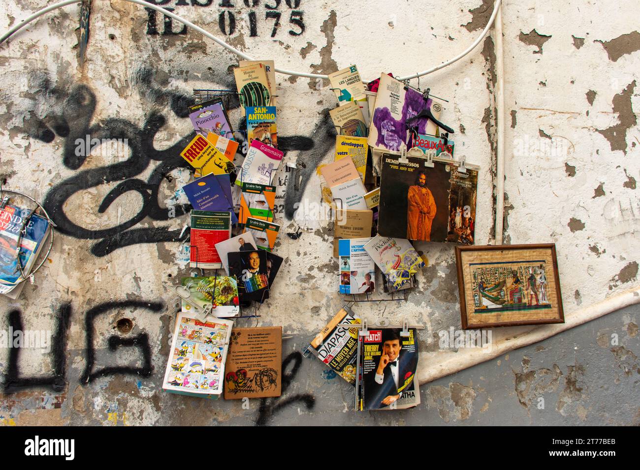 Old books and magazines on the wall in the flea market in Algiers City ...