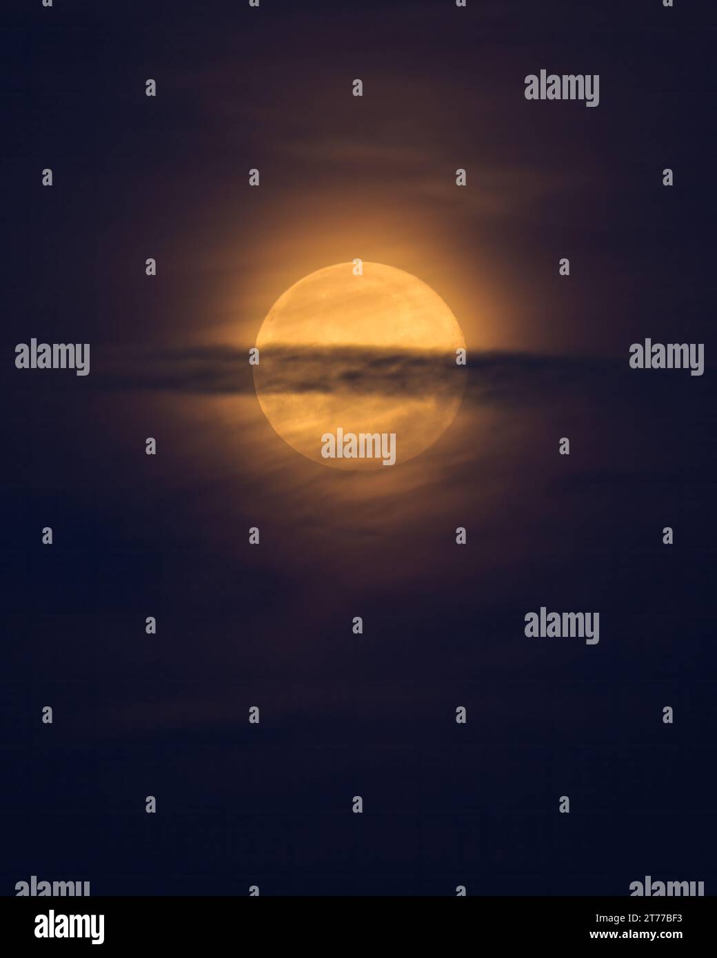 Yellow full moon behind clouds in northern France in summer Stock Photo ...