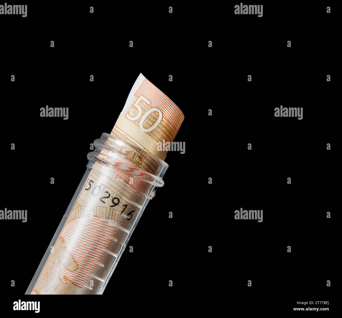 euro banknotes in graduated test tube, the cost of medical health on a ...