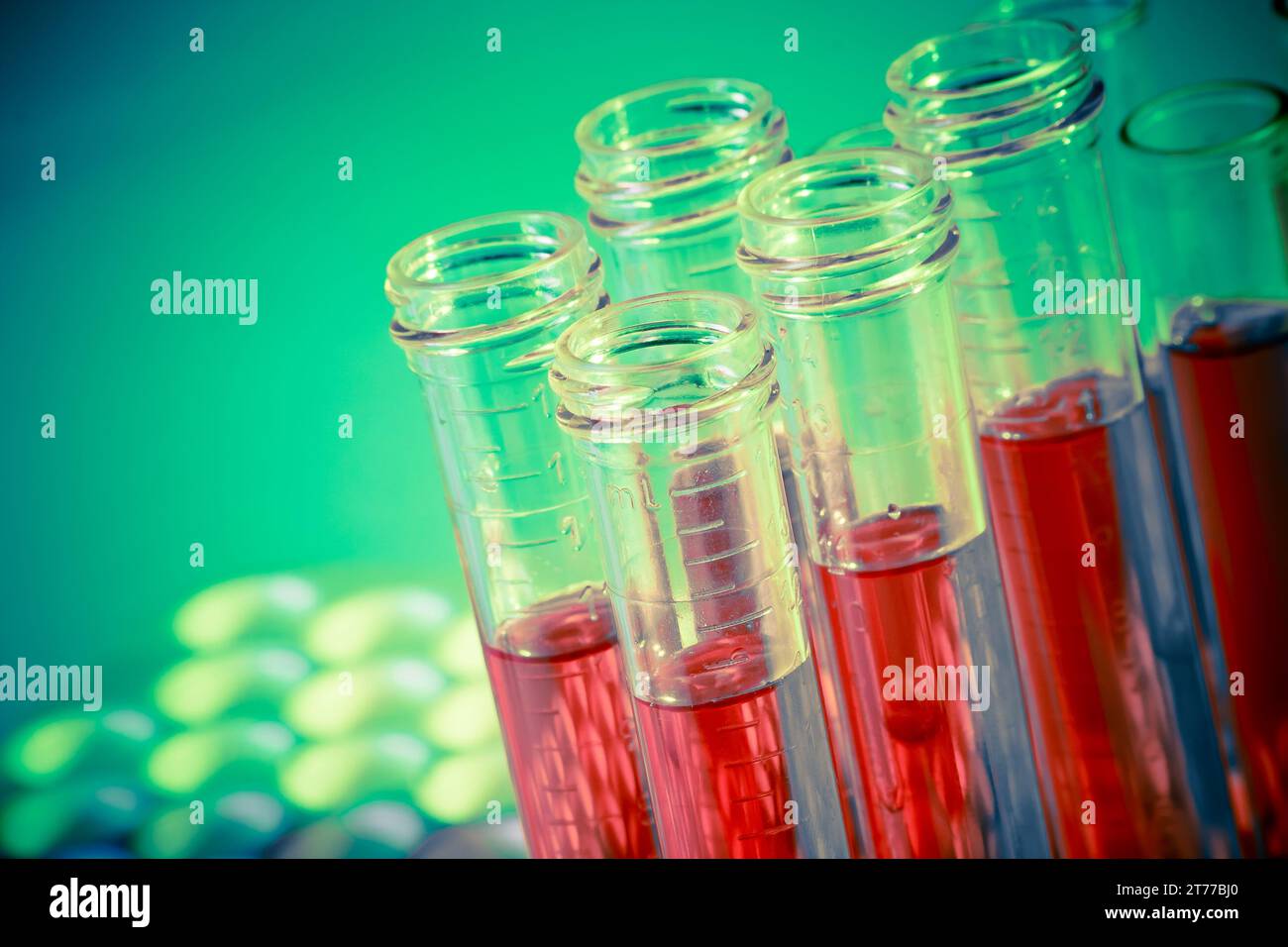 test tubes with red liquid in laboratory on green and yellow light tint ...