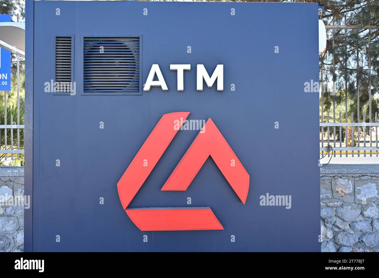 Side view on blue ATM machine of Eurobank standing alone in the area of ...