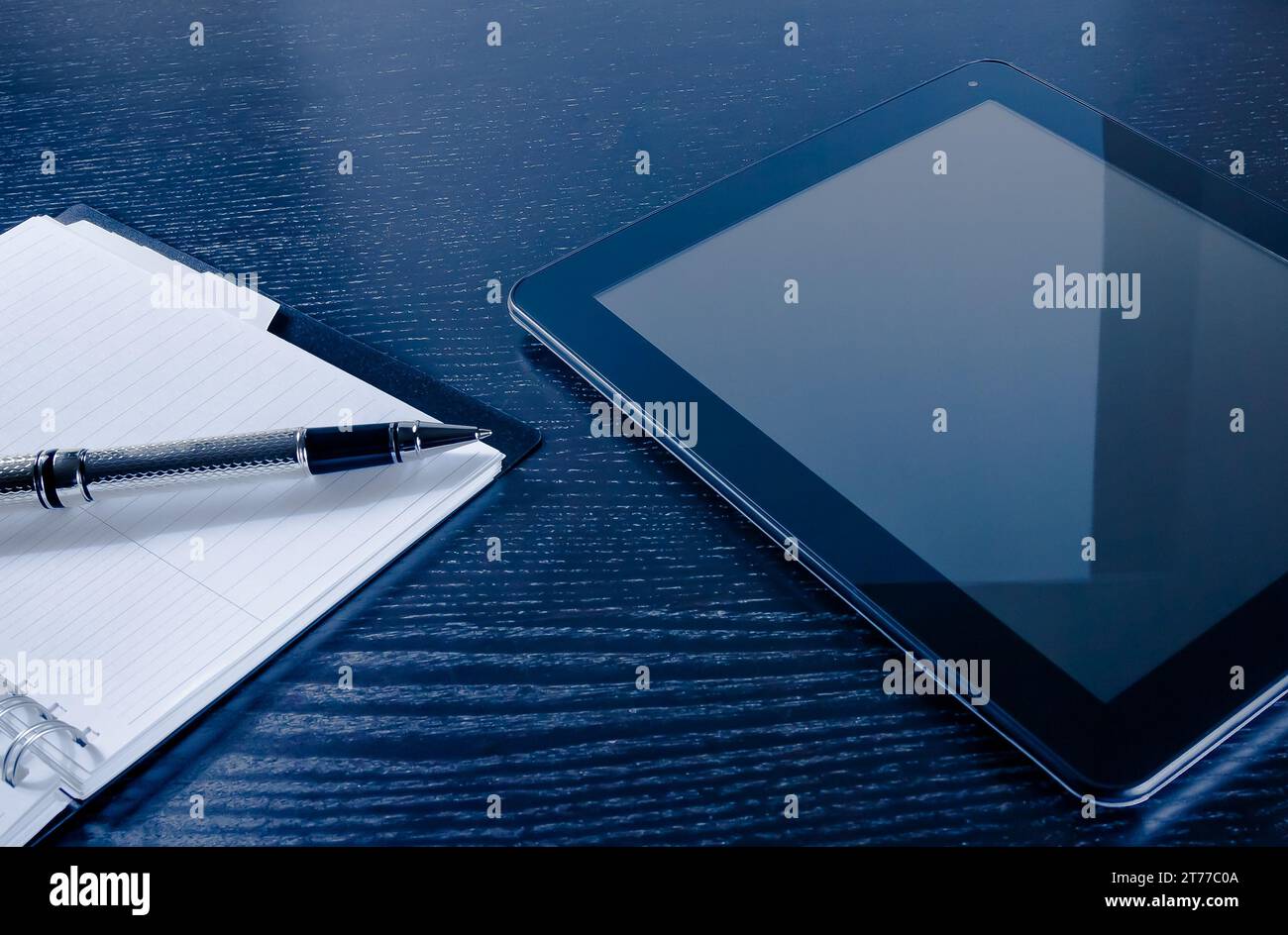 tablet near notes on wood black table, concept of new technology Stock ...