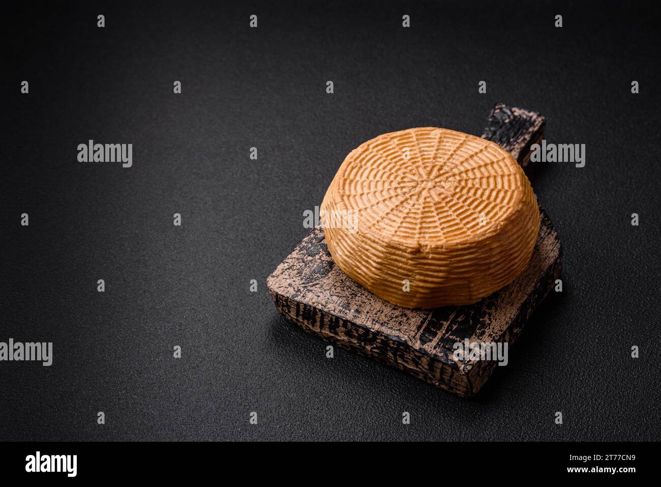 Delicious hard craft cheese made from cow or goat milk on a dark ...