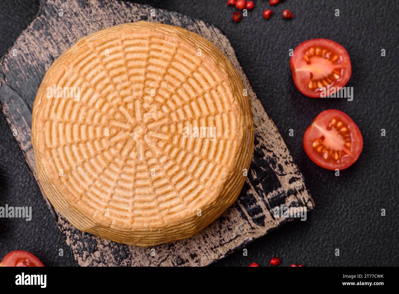 Delicious hard craft cheese made from cow or goat milk on a dark ...