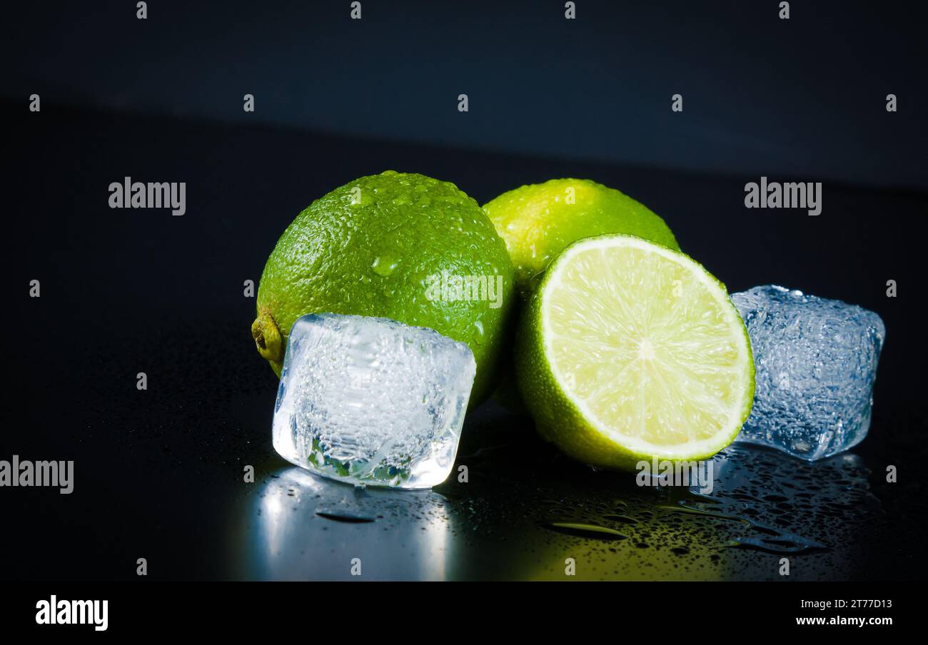 Lime with ice cubes on black background with space for text Stock Photo ...
